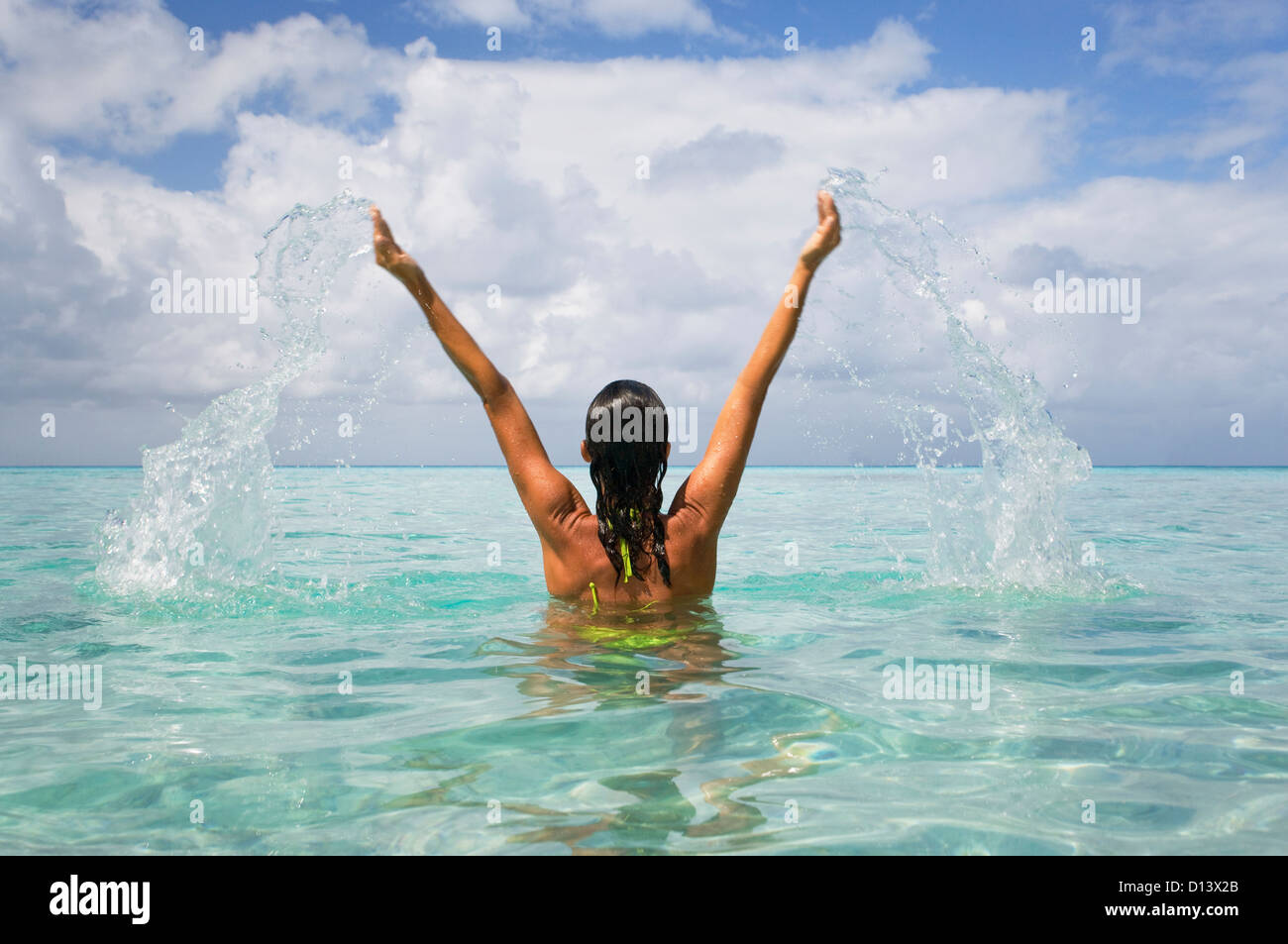 Woman Splashing In Tropical Ocean Water Stock Photo - Alamy