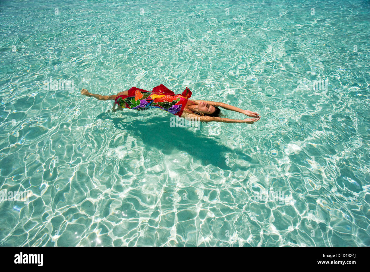 Woman Floating In Tropical Ocean Water Stock Photo - Alamy