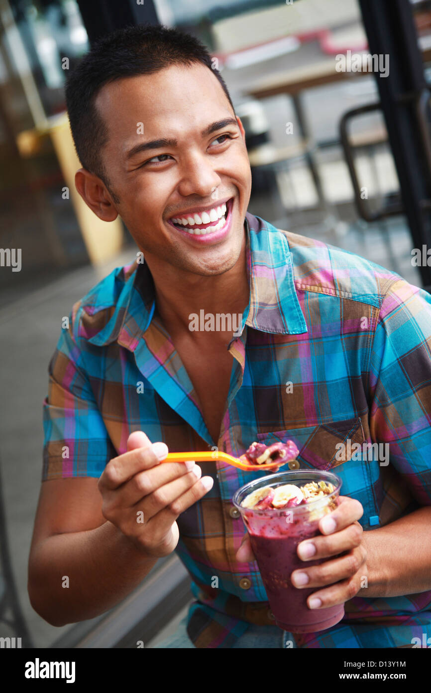 Hawaii, Oahu, Young Local Man Eating And Enjoying A Delicious Acai Cup ...