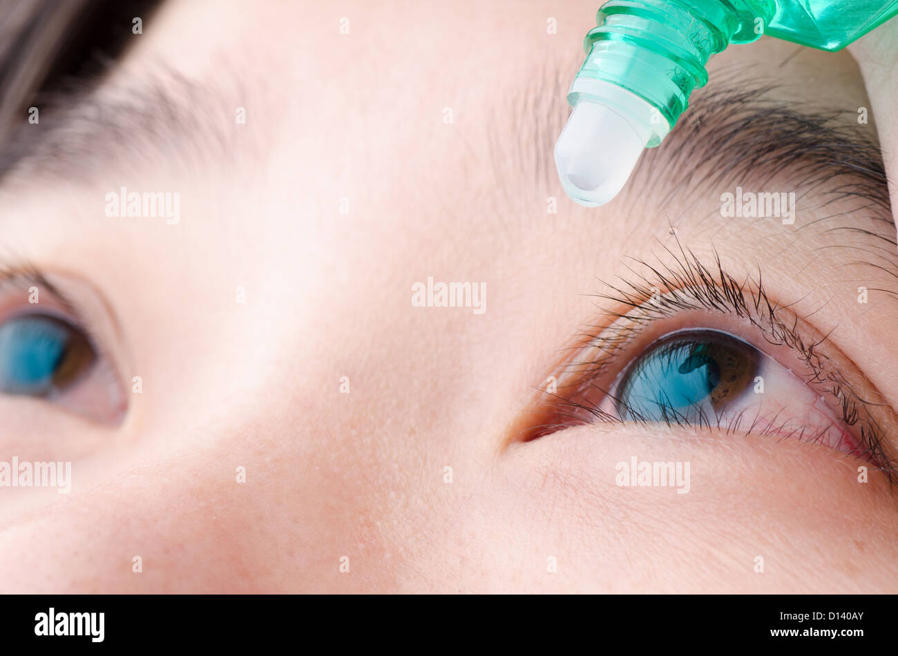 young woman applying eye drop Stock Photo - Alamy