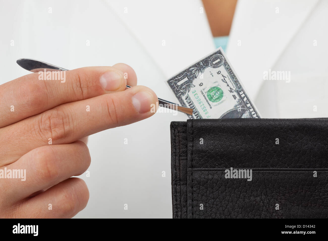 Close-up of woman holding one dollar bill via tweezer Stock Photo - Alamy