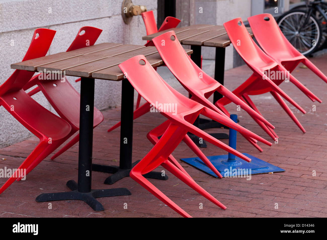 Red chairs leaning on tables Stock Photo - Alamy