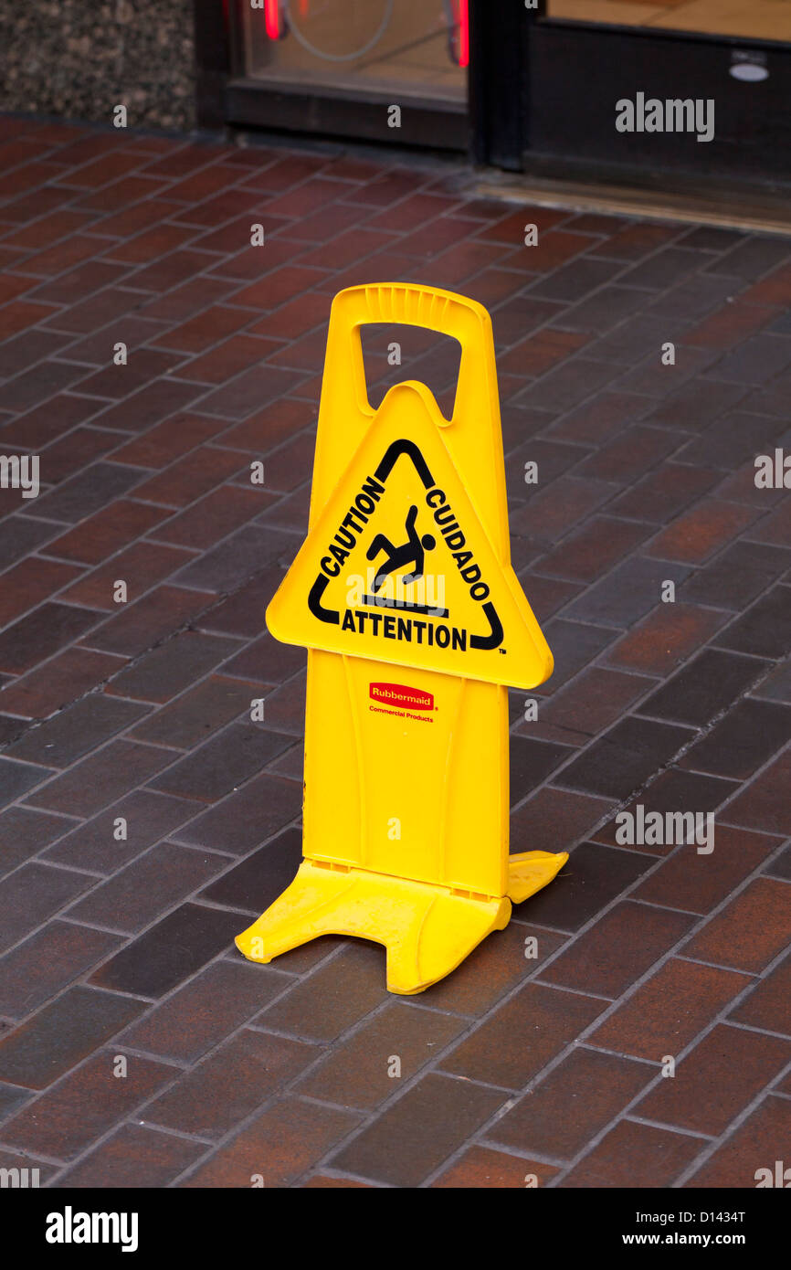 Wet floor sign on tile floor Stock Photo - Alamy