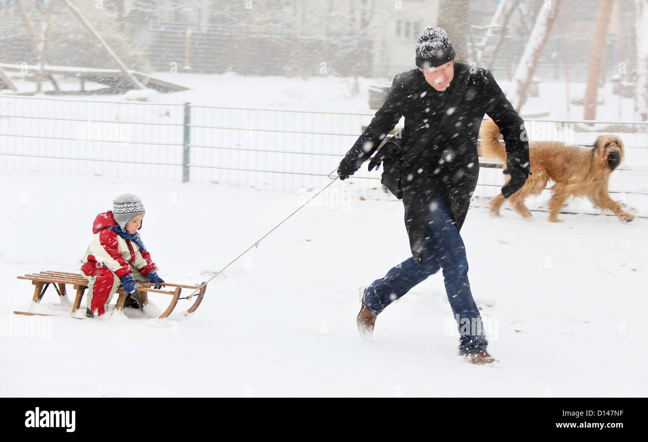 A father pulls his child to kindergarten on a sled in Berlin, Germany ...