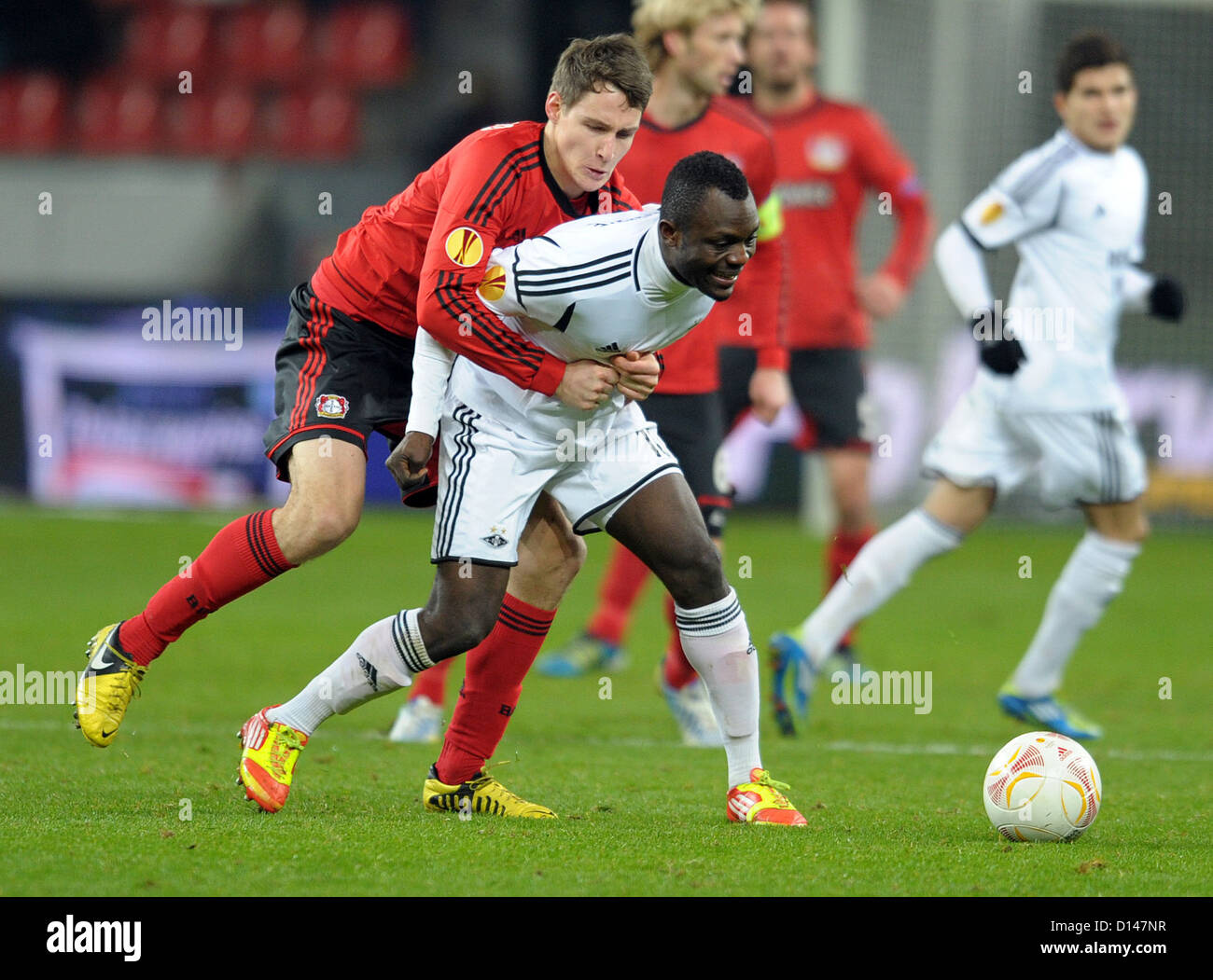 Leverkusen's Philipp Wollscheid (L) and John Chibuike of Trondheim vie ...