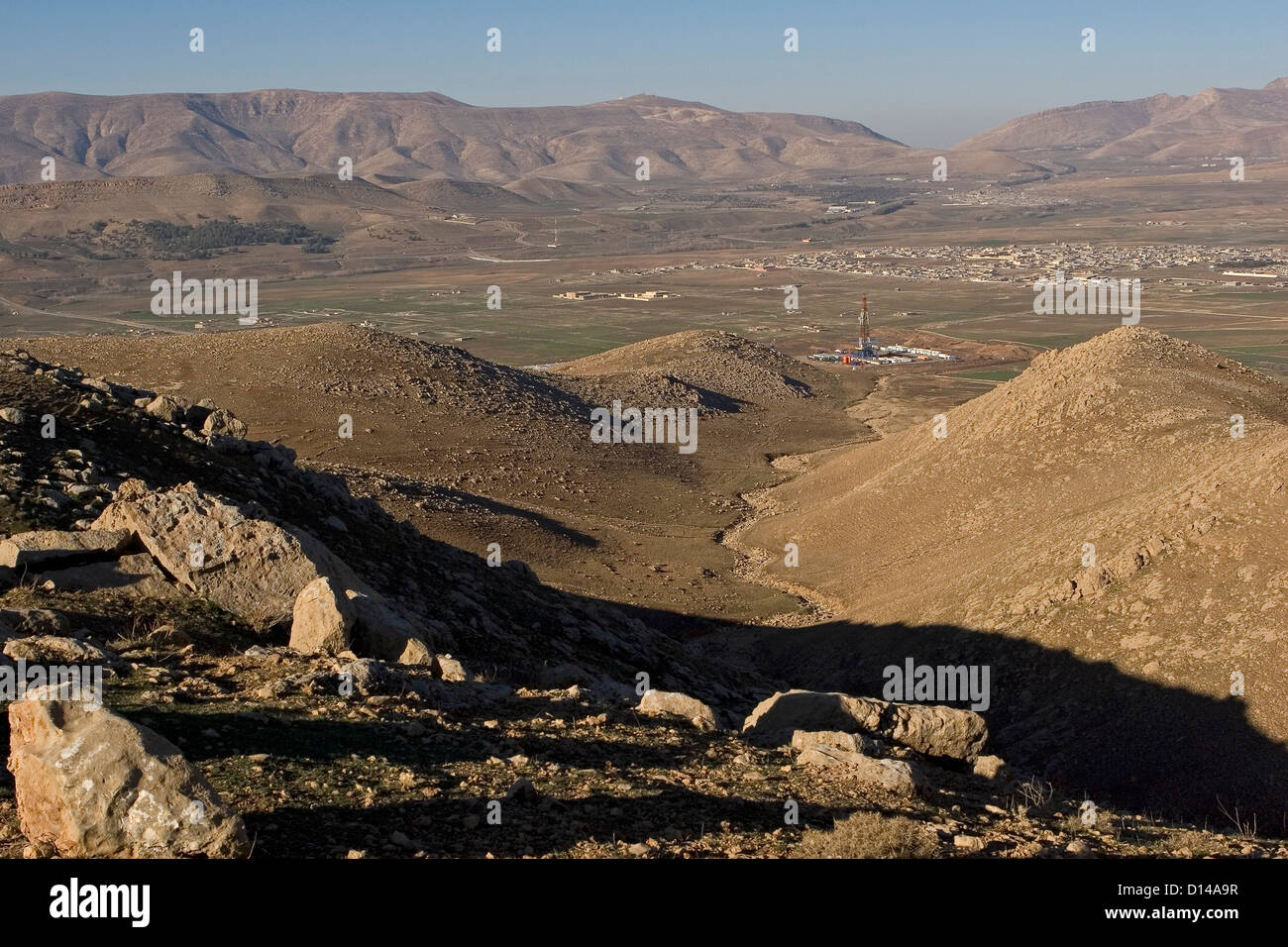 Oil and gas exploration rig site in center of valley at end of gorge ...