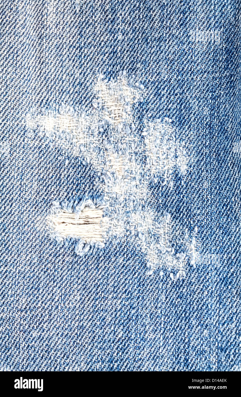 Hole on jeans denim fabric texture Stock Photo - Alamy