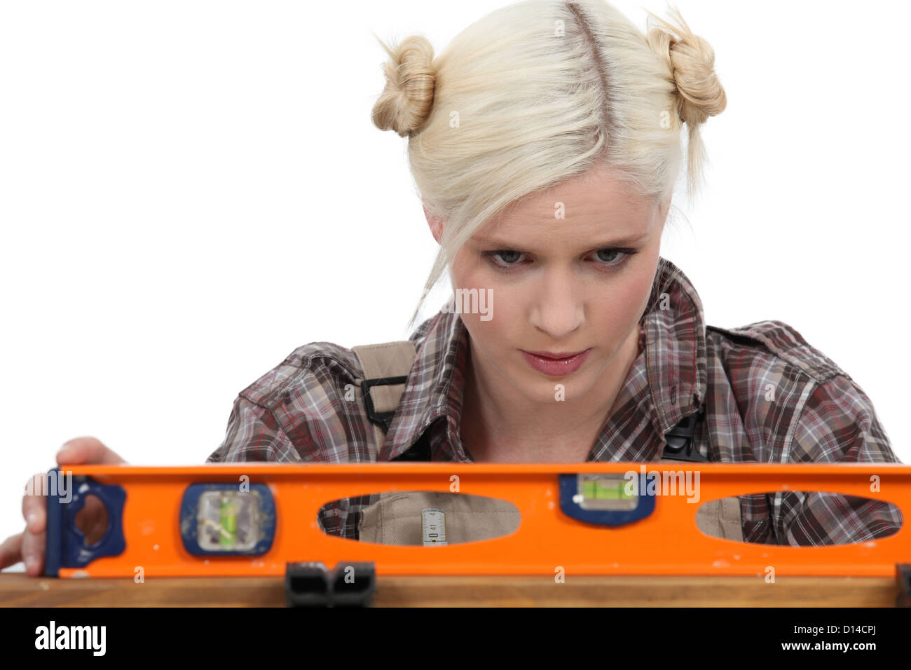 Blond woman using spirit level Stock Photo - Alamy