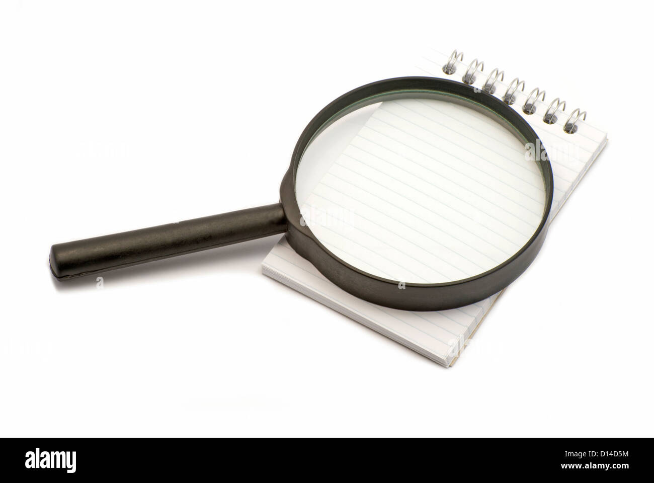 Notebook and magnifier on white background Stock Photo - Alamy