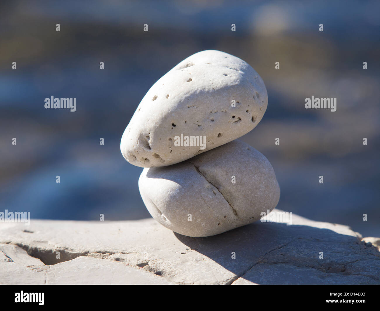 two stones on the blue sea Stock Photo - Alamy