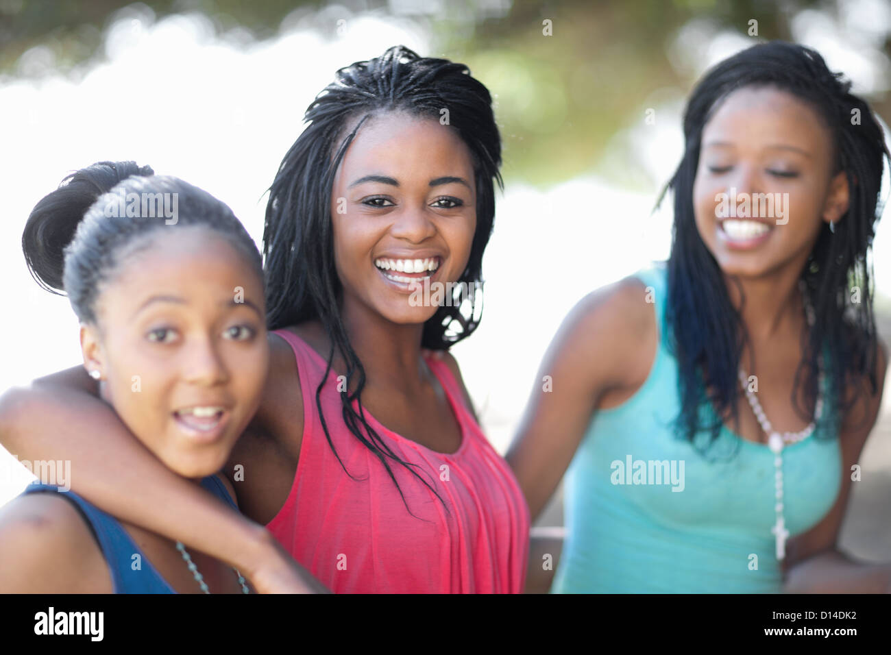 Smiling women hugging outdoors Stock Photo - Alamy