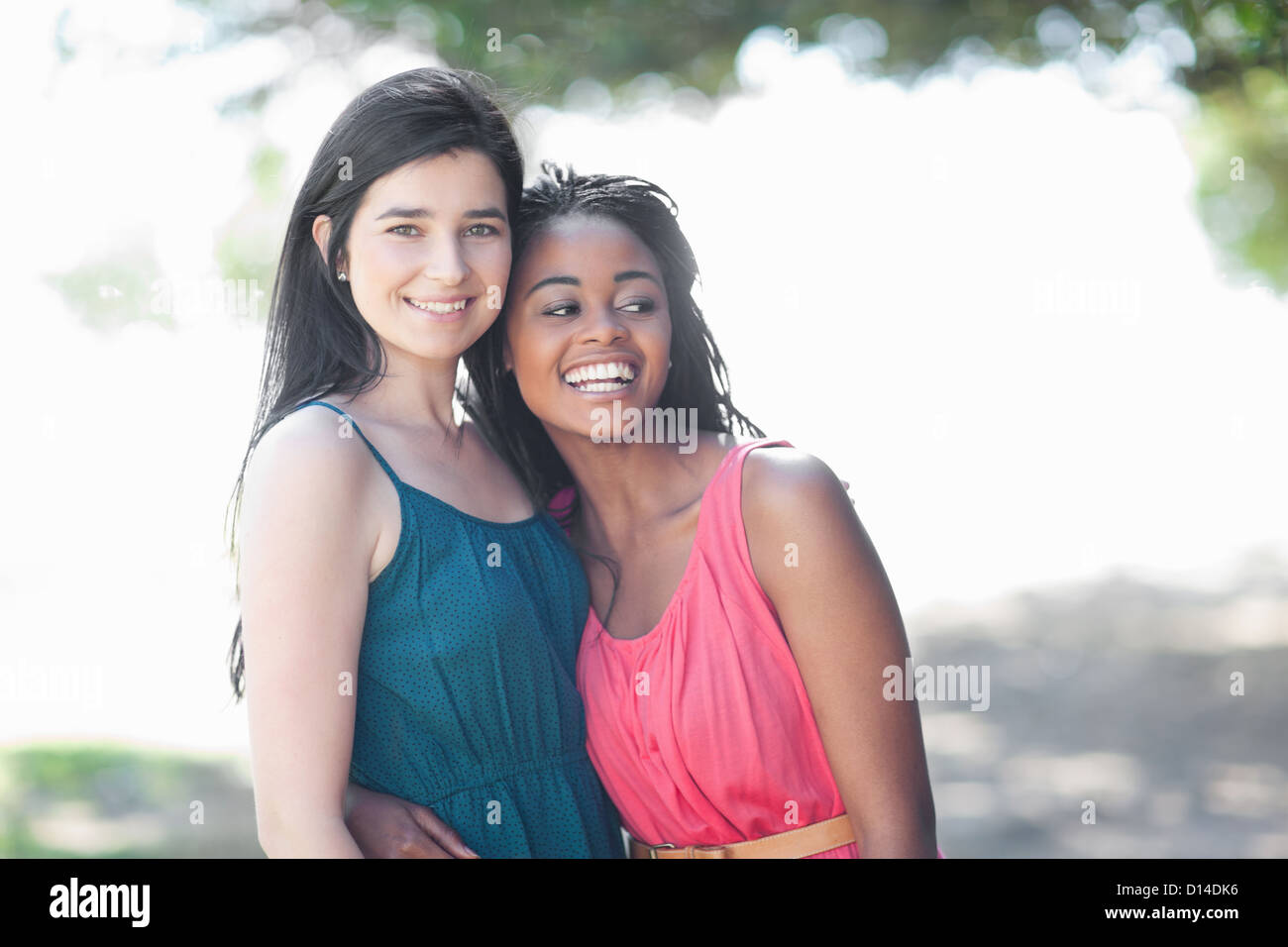 Smiling women hugging outdoors Stock Photo - Alamy
