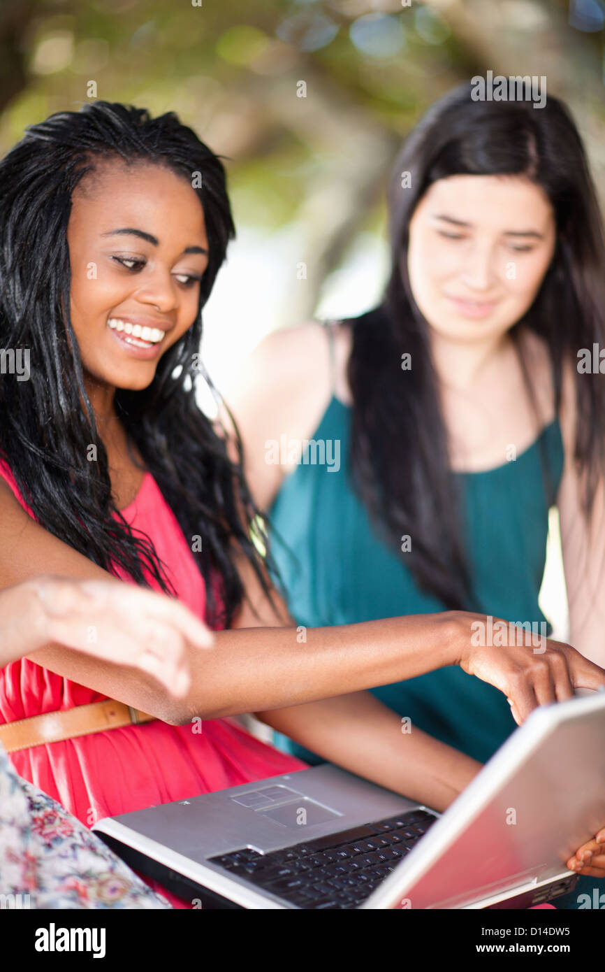 Three women sitting on a tree branch hi-res stock photography and ...