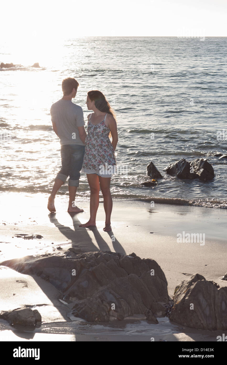 Couple standing together on beach Stock Photo - Alamy
