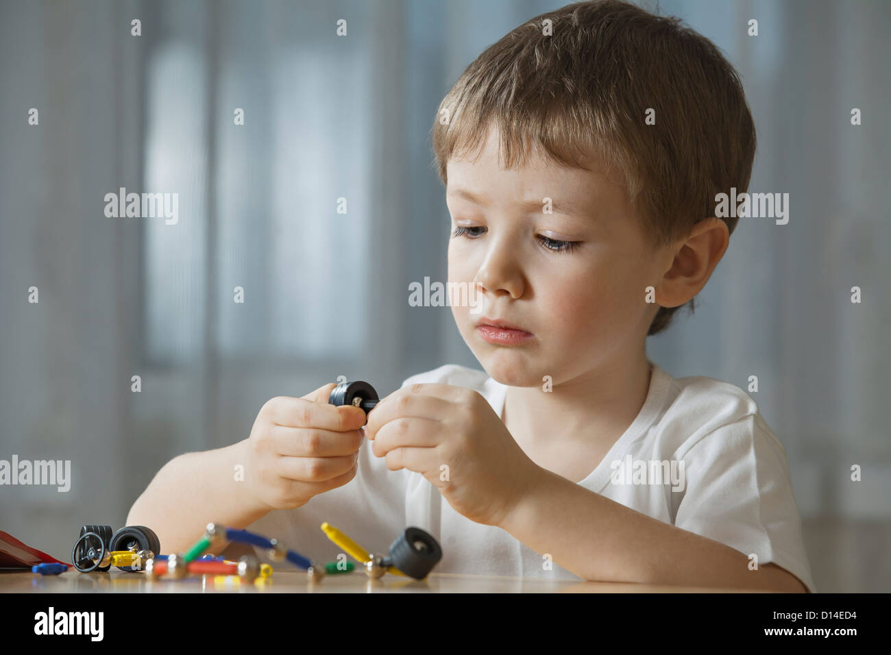 young boy playing with shape game Stock Photo - Alamy