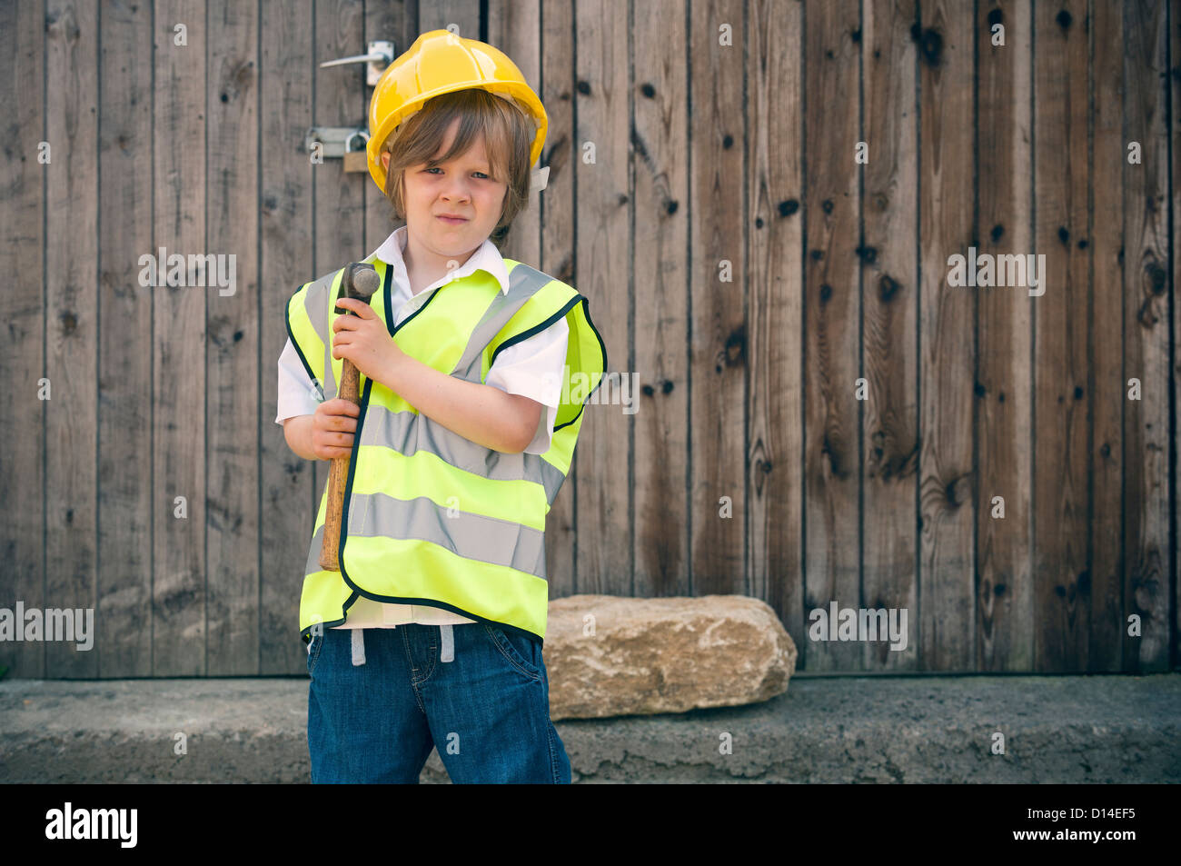 Boy playing construction worker Stock Photo - Alamy