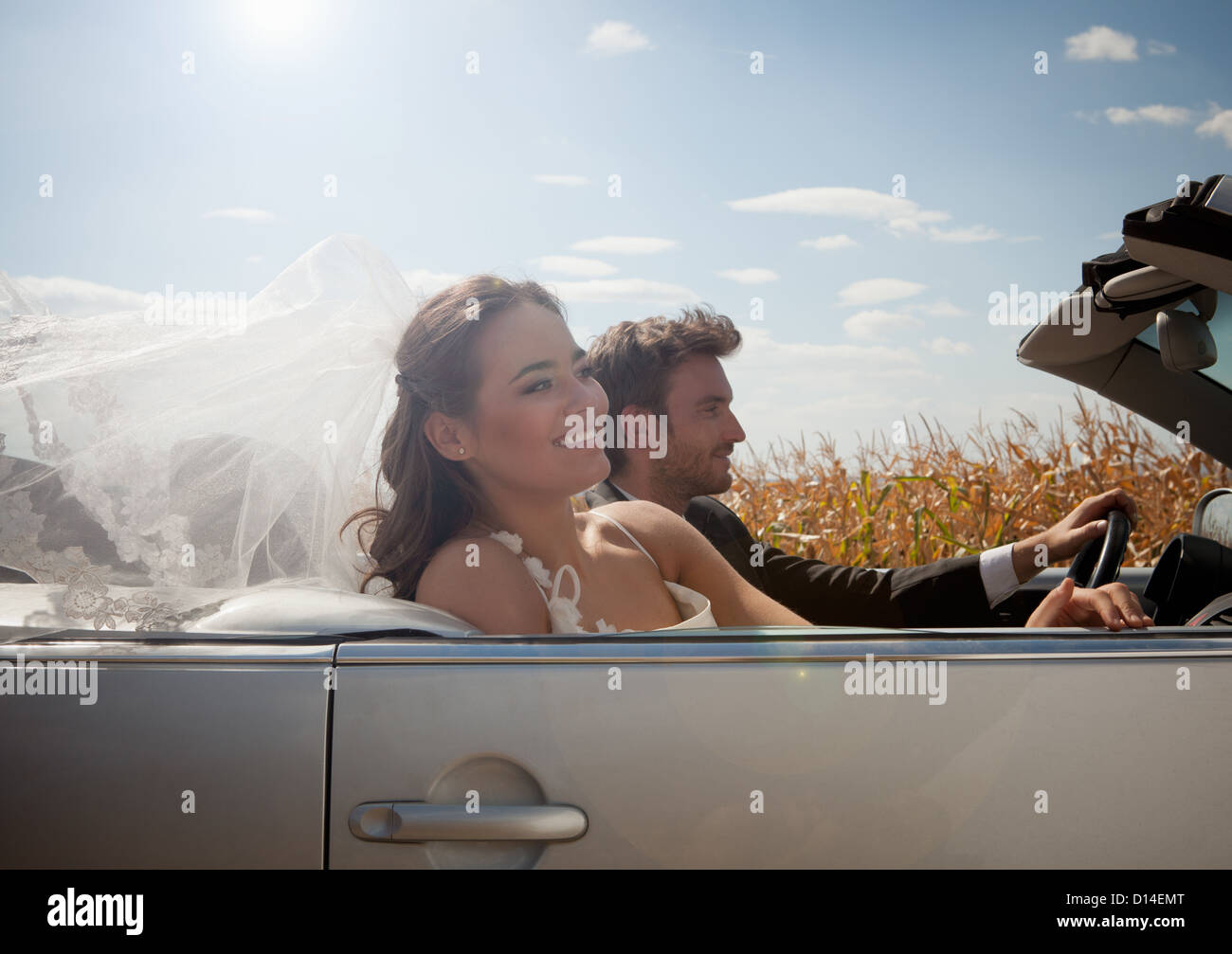 Newlywed couple driving in convertible Stock Photo - Alamy