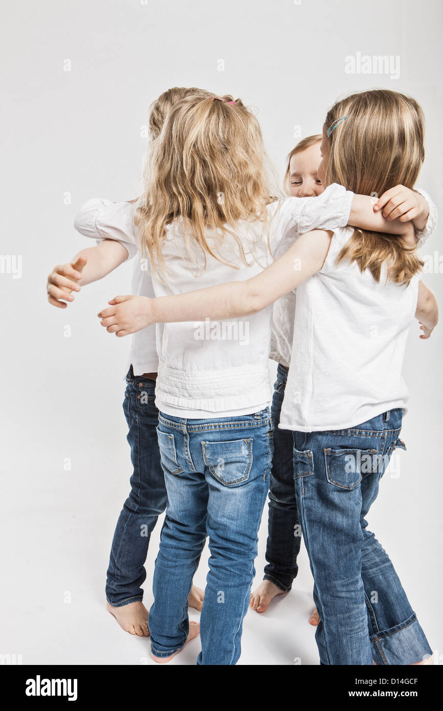Smiling children hugging Stock Photo - Alamy