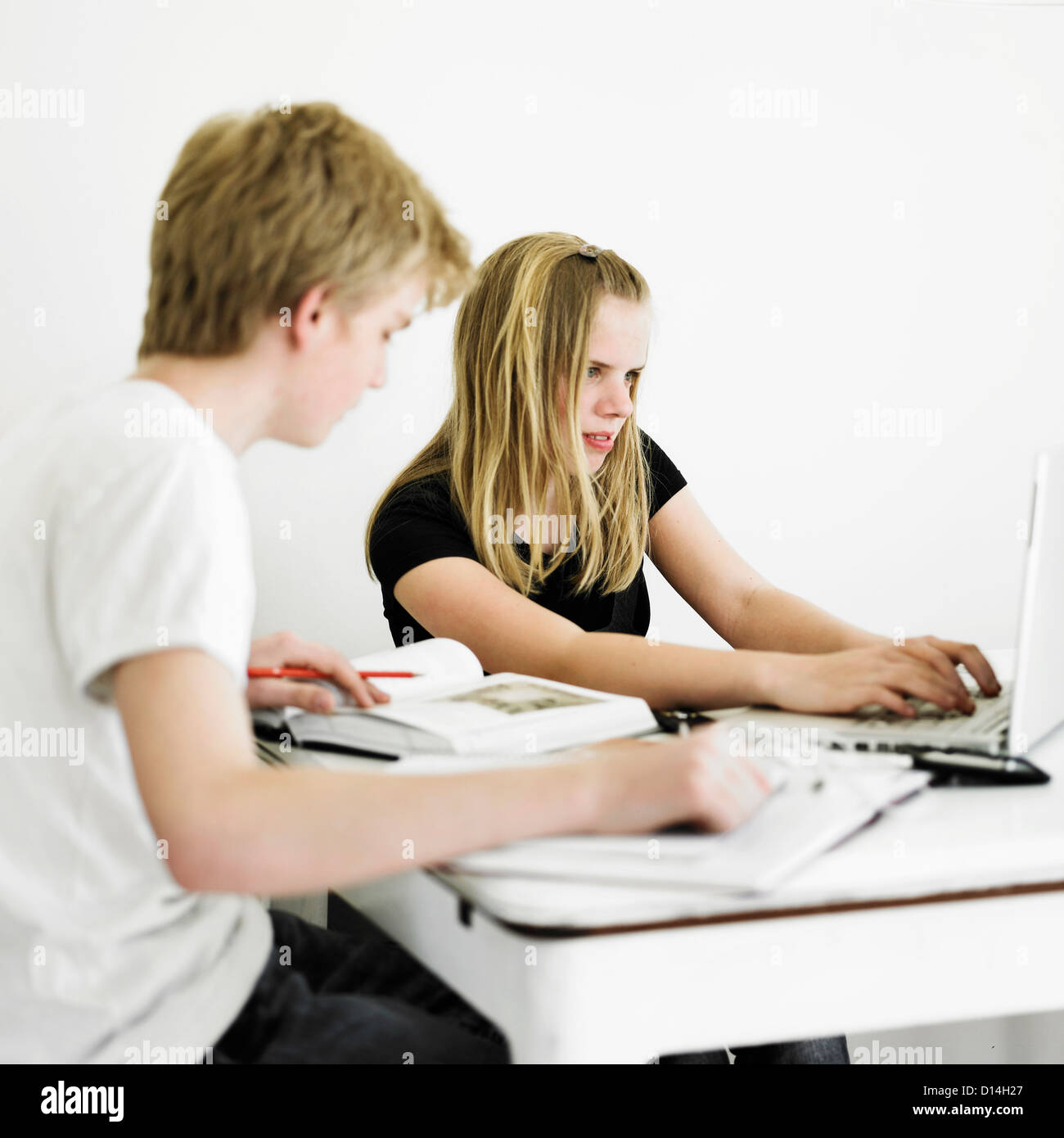 Students working together at table Stock Photo - Alamy