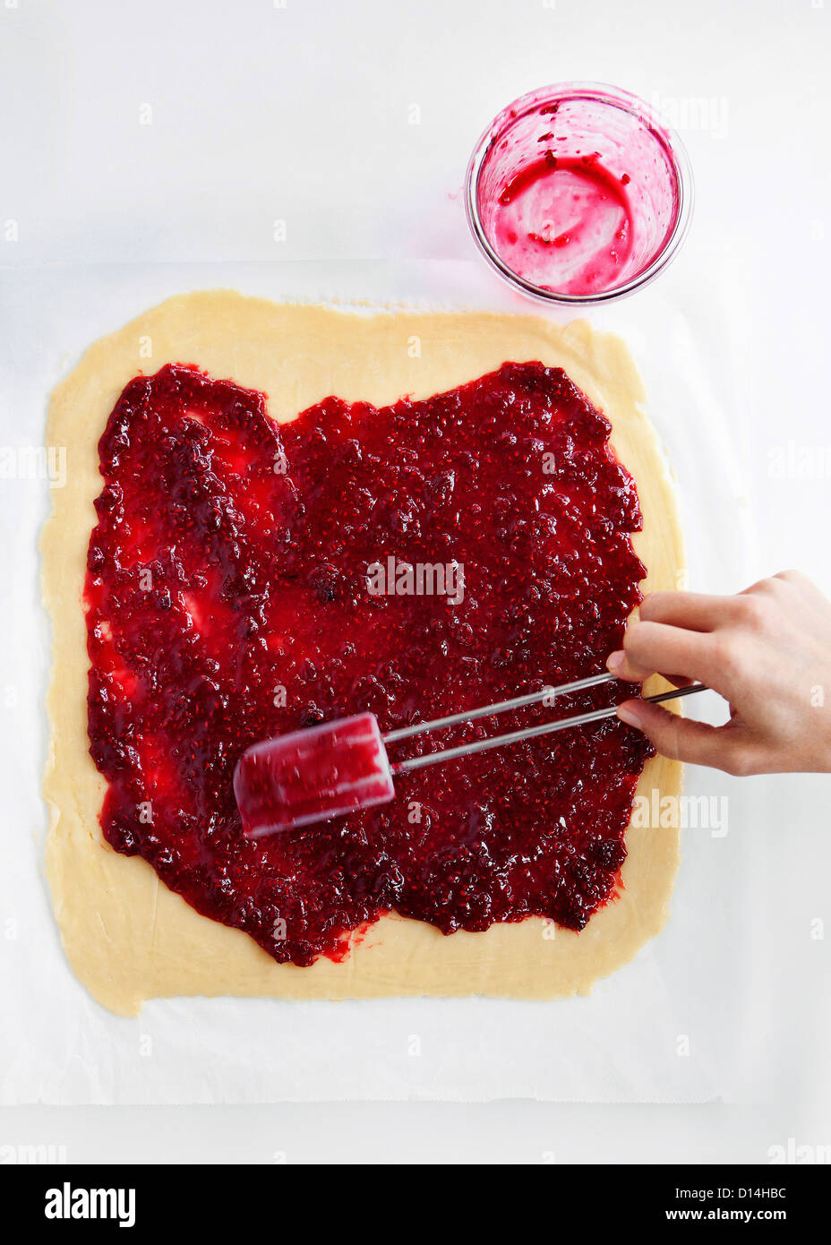 Hand spreading jam on dough Stock Photo - Alamy