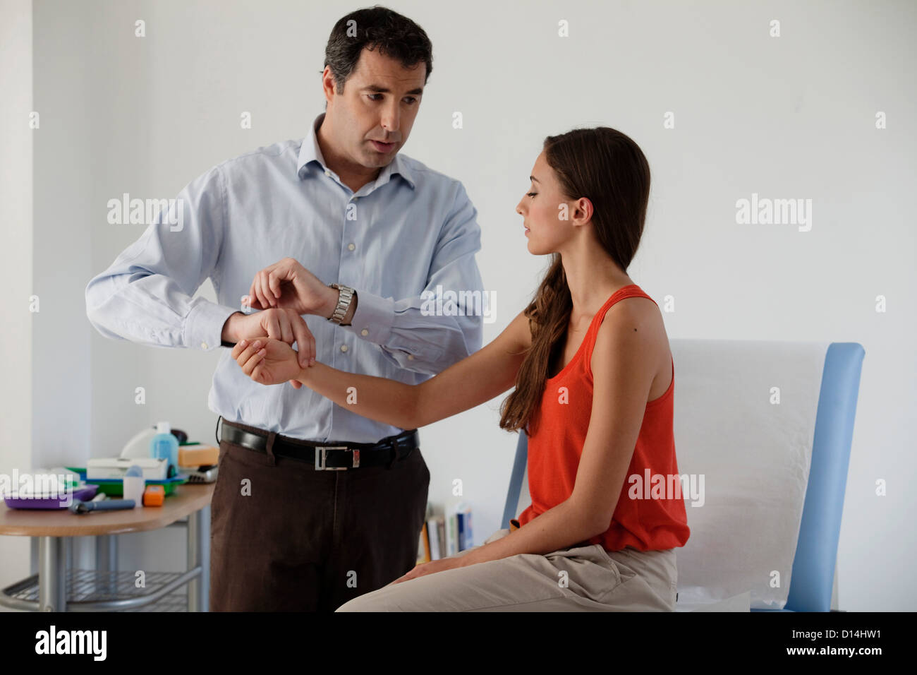 TAKING A WOMAN'S PULSE Stock Photo - Alamy