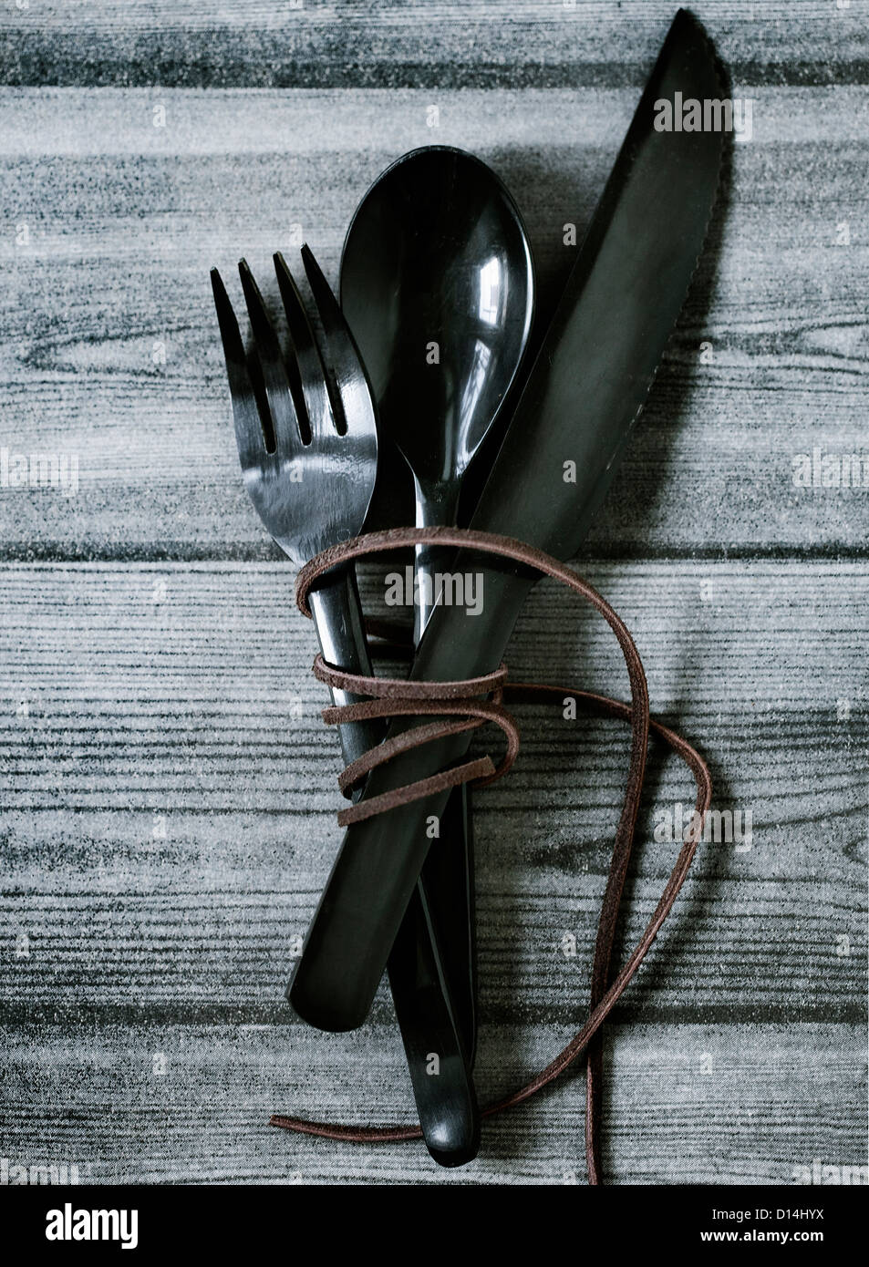 Wrapped cutlery on wooden table Stock Photo - Alamy