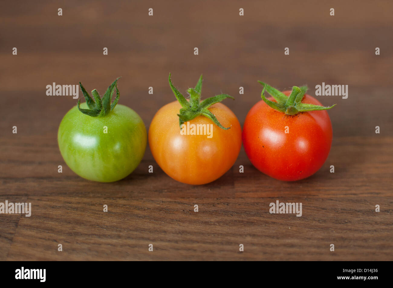 Different colored tomatoes on table Stock Photo - Alamy