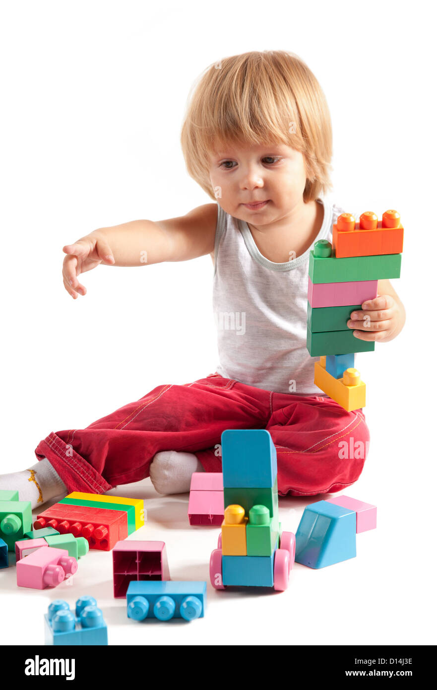 Cute little boy playing with blocks, isolated on white background Stock ...