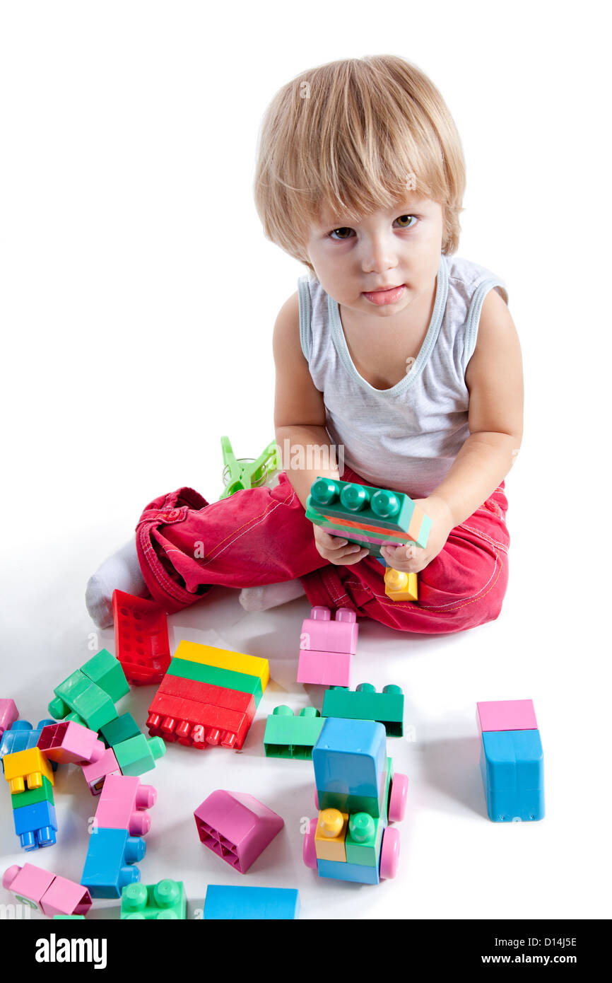 Little boy playing with colorful blocks, studio shot, high angle view ...