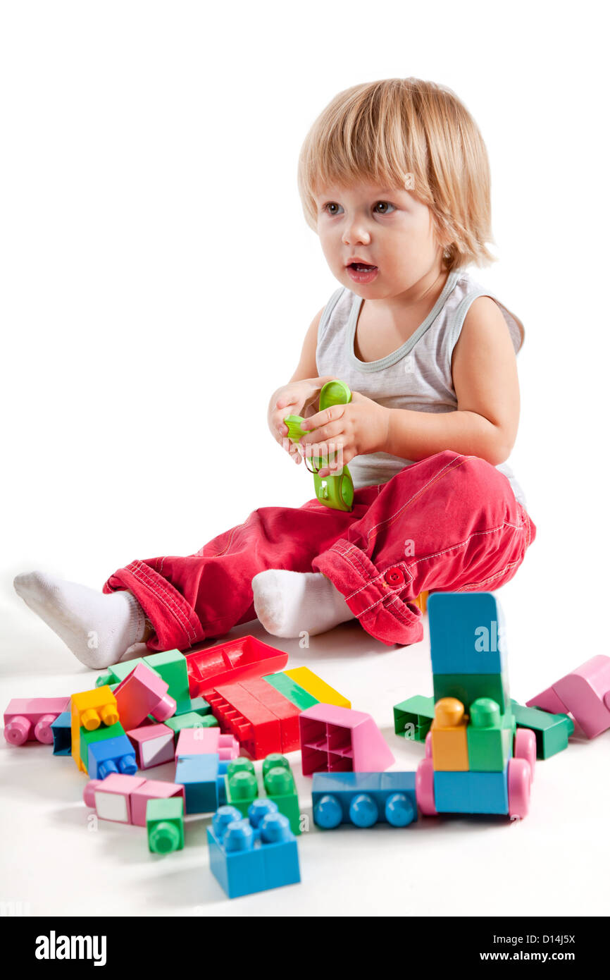 Cute little boy playing with colorful blocks, studio shot Stock Photo ...