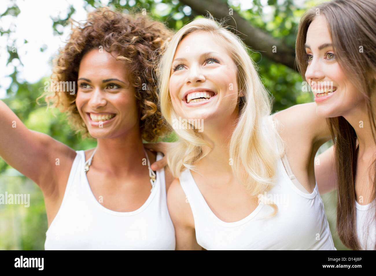Smiling women standing together Stock Photo - Alamy