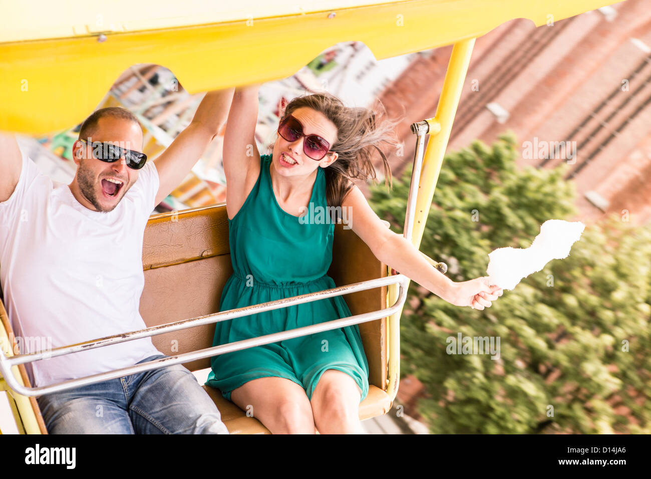 Couple riding amusement park ride Stock Photo - Alamy
