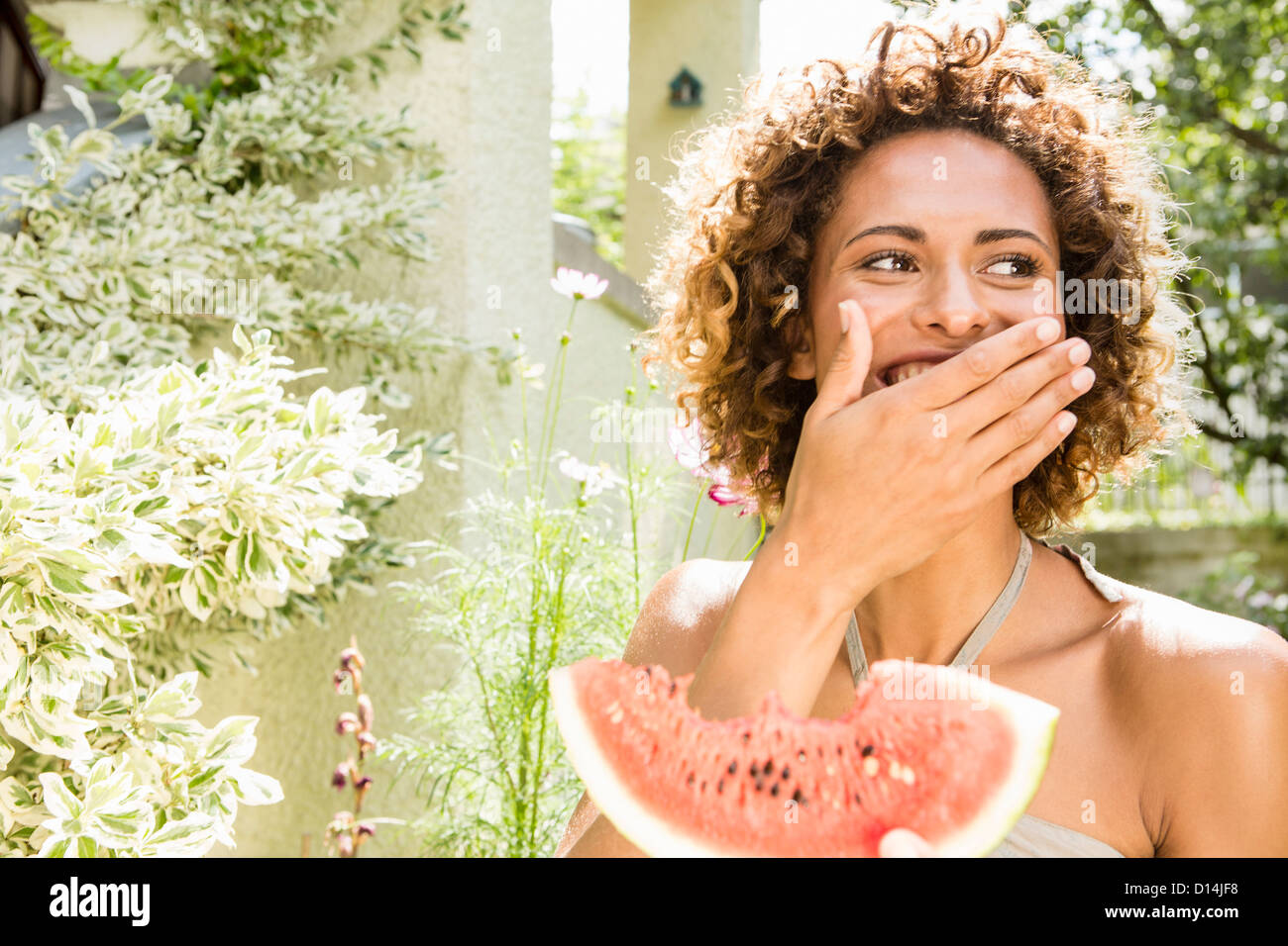 Smiling woman eating watermelon Stock Photo - Alamy