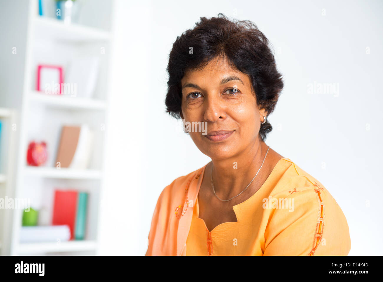 Portrait of a 50s Indian mature woman smiling, isolated on white ...