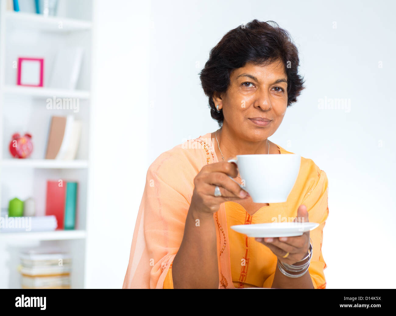 Mature Indian woman drinking coffee / tea at home Stock Photo - Alamy
