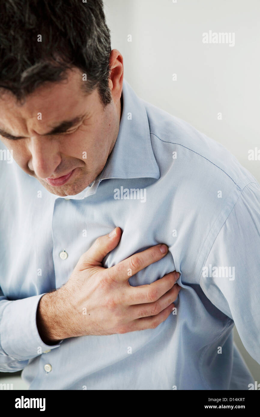 MAN WITH HEART ATTACK Stock Photo - Alamy
