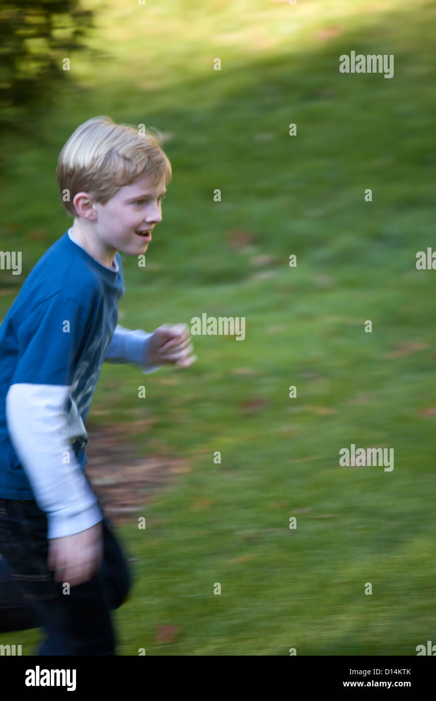 Young Boy Running on Lawn Stock Photo - Alamy