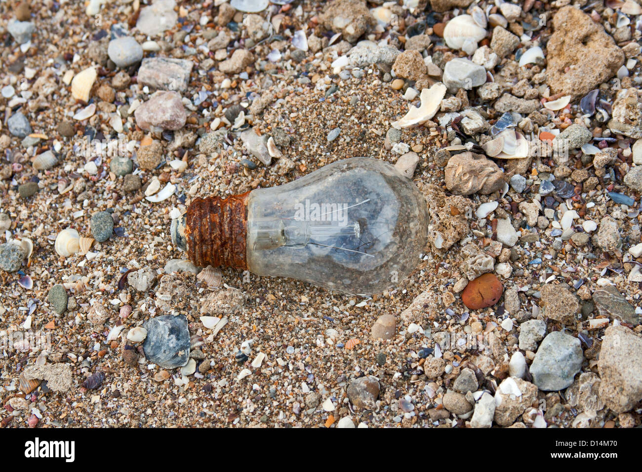 Rusty light bulb on sea pebble background Stock Photo - Alamy