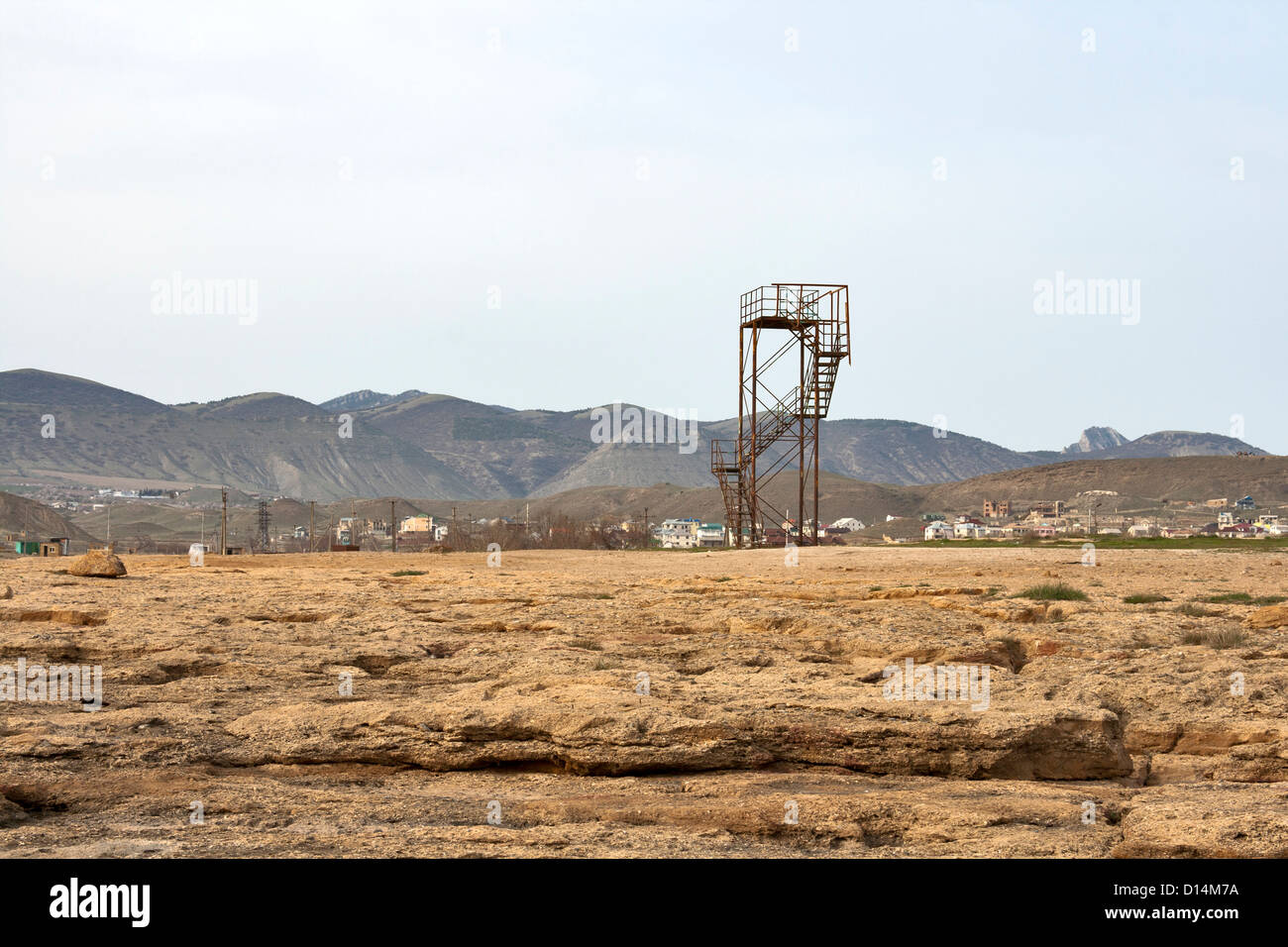 Abandoned rusty observation tower on rocky sea beach. Sudak, Crimea ...