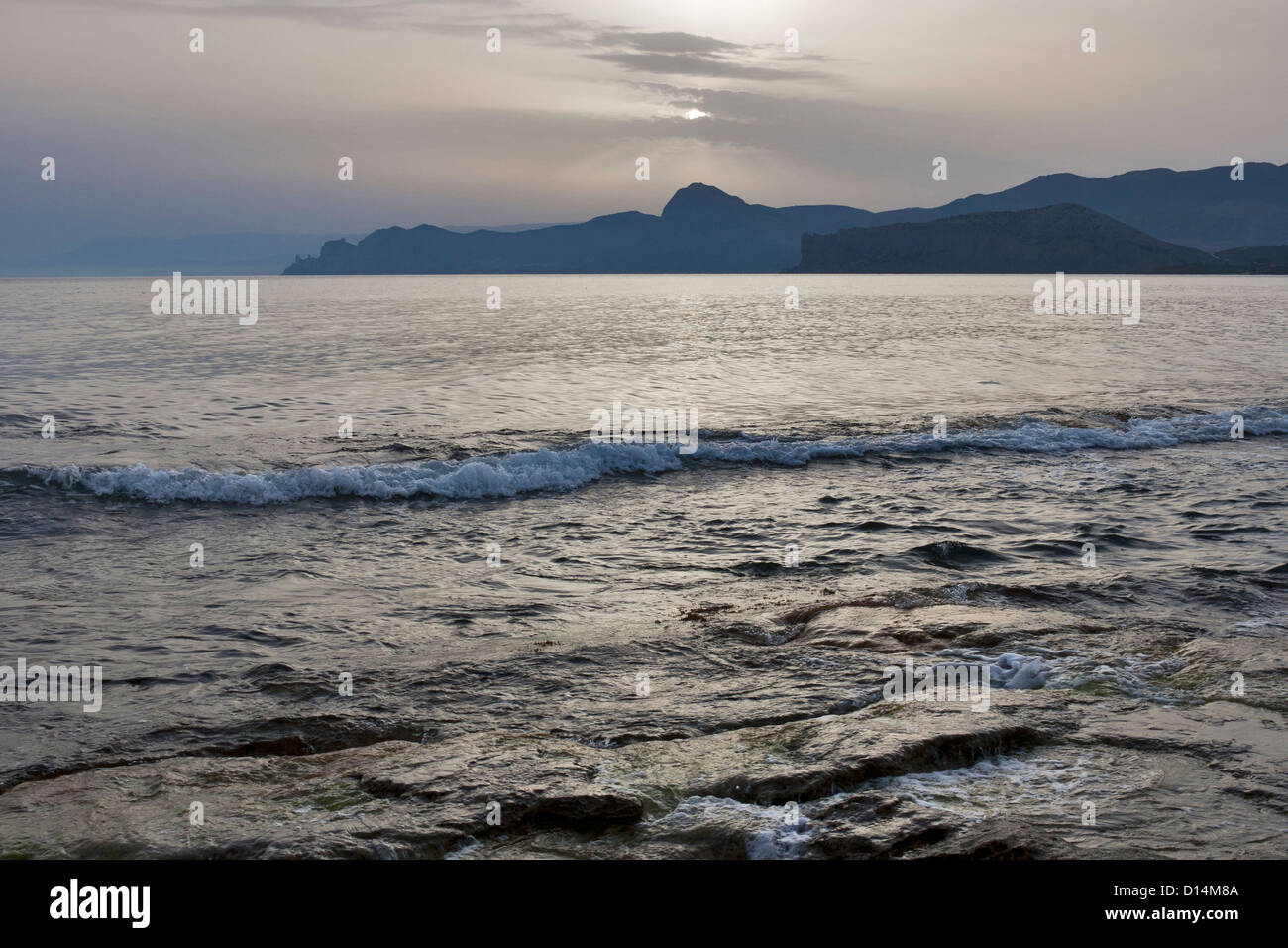 Mystic evening sea with ripple waves Stock Photo - Alamy