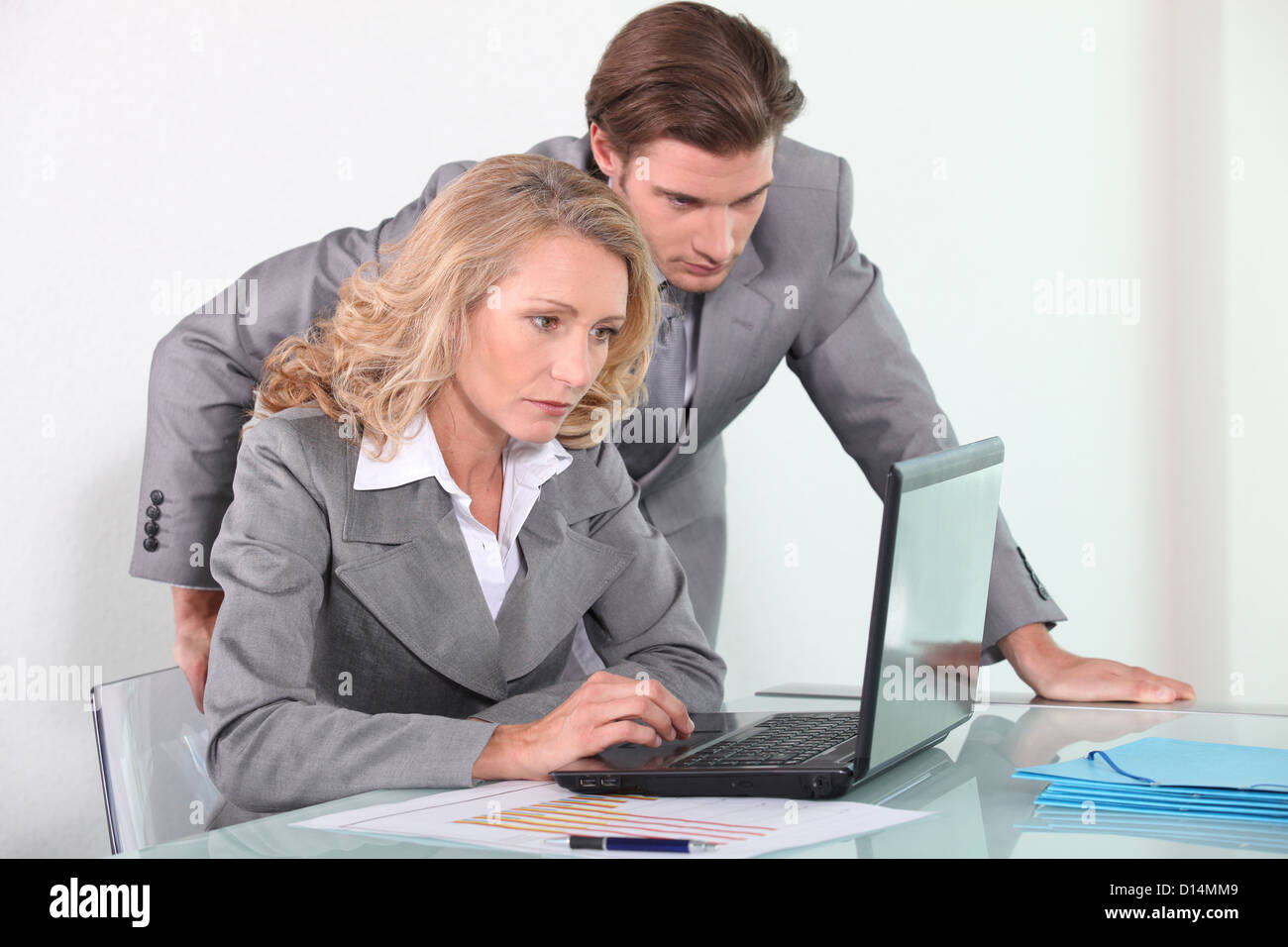 Executives with laptop computer Stock Photo - Alamy