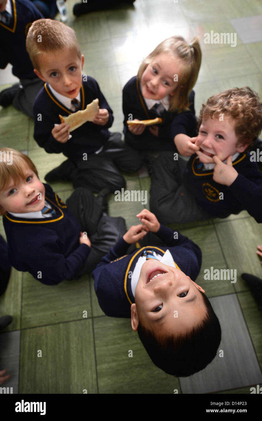 A schoolboy eating toast after morning assembly at Our Lady & St ...