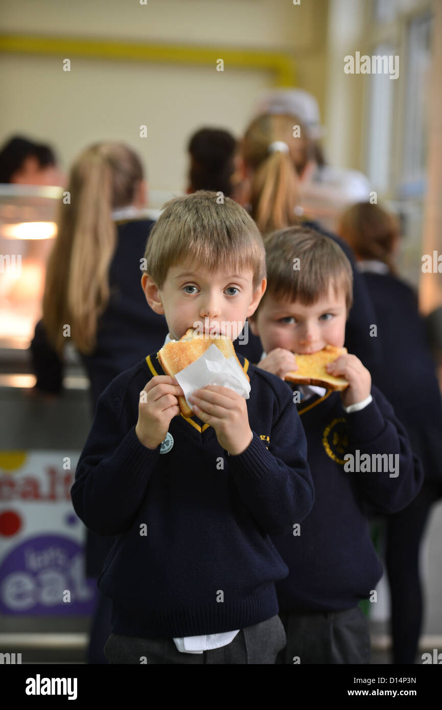 A schoolboy eating toast after morning assembly at Our Lady & St ...