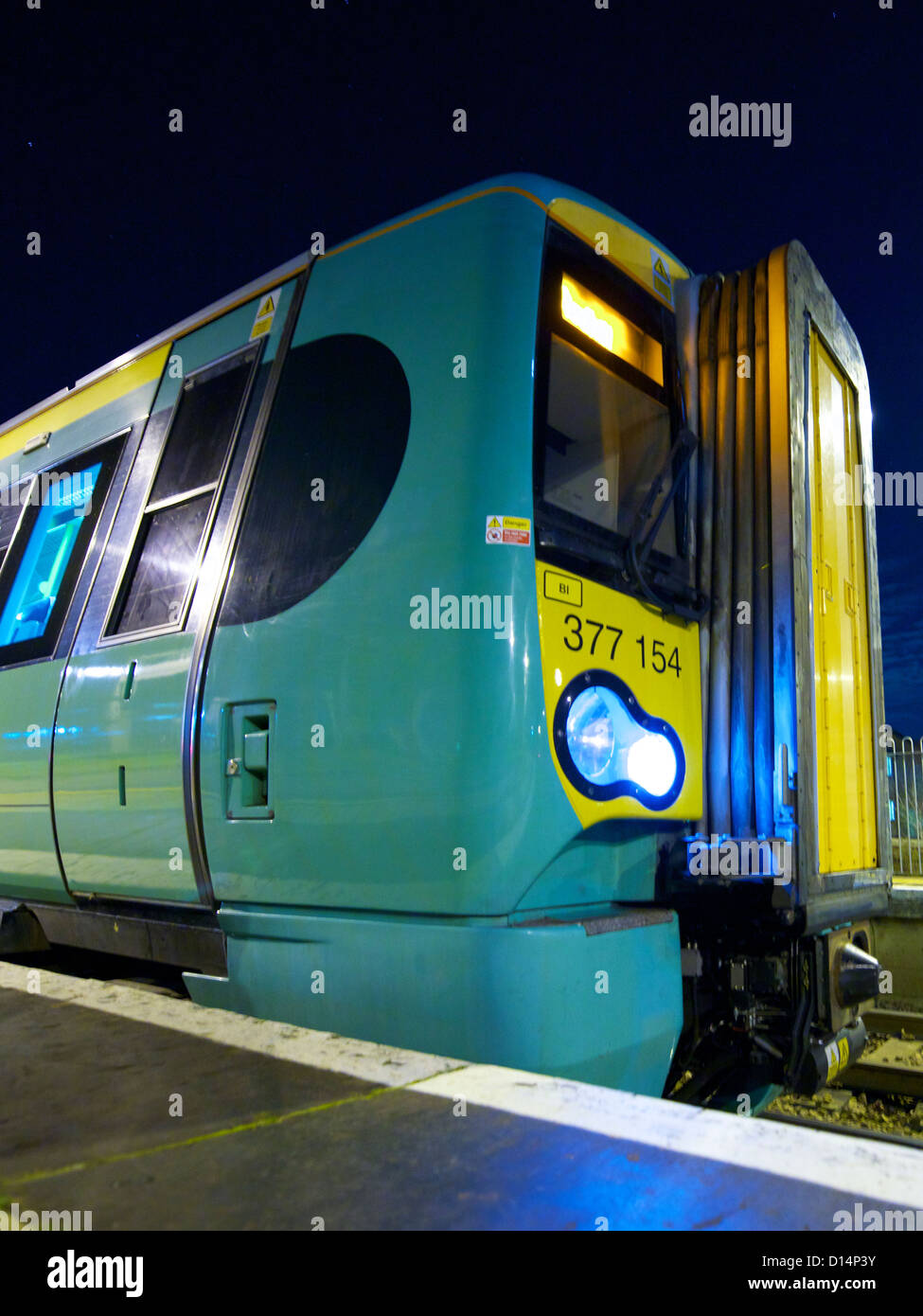 "Electrostar" under a starlit and moonlit night sky, an empty railway ...