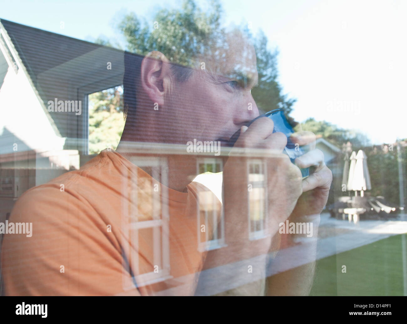 Man having coffee reflected in window Stock Photo - Alamy