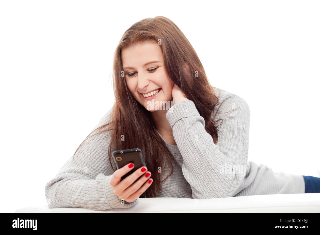 young girl reading text message on her phone, smiling Stock Photo - Alamy