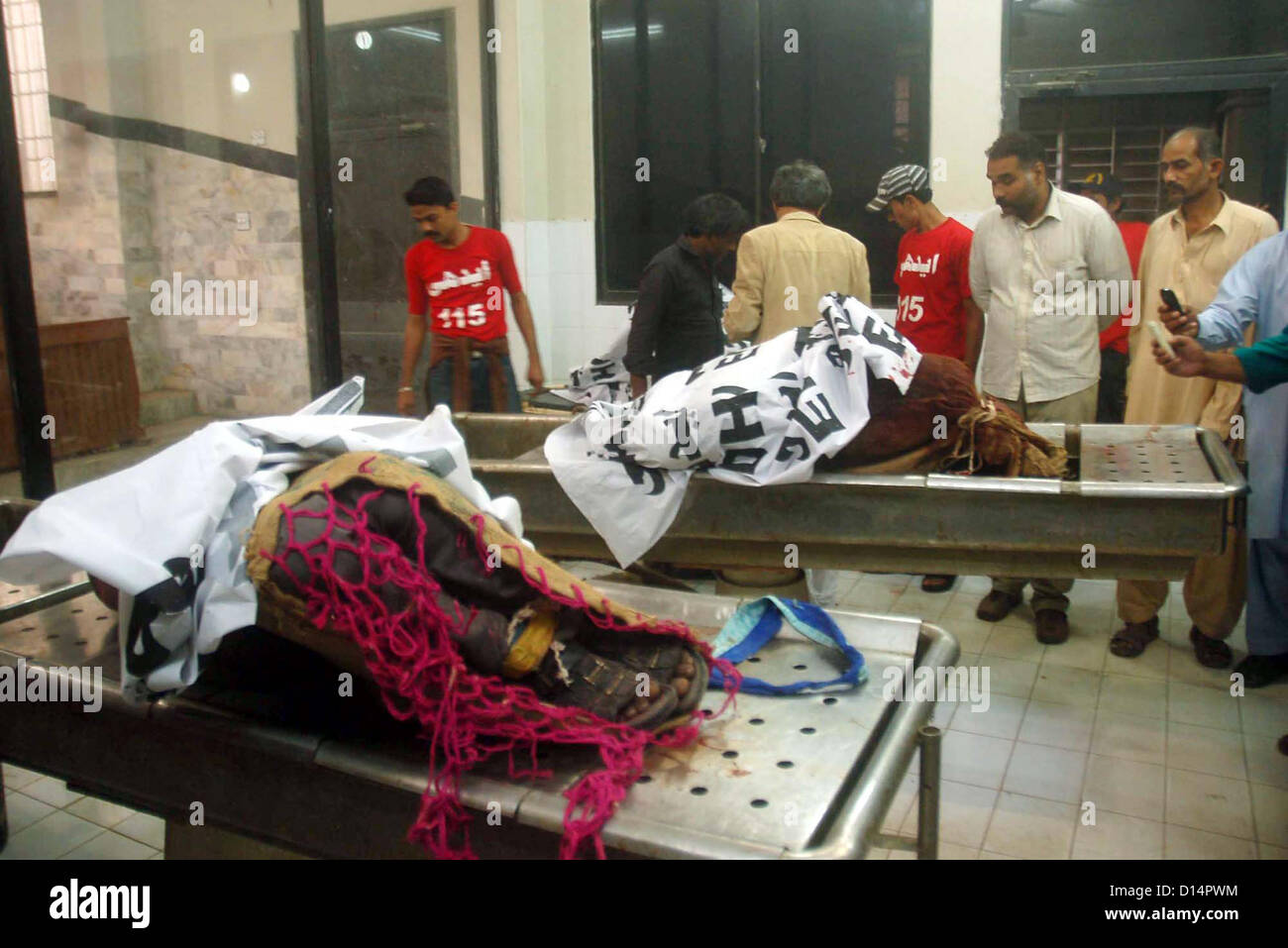 People gather near three unidentified dead bodies that were found Stock ...