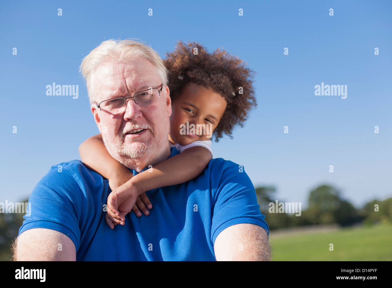Girl hugging grandfather outdoors Stock Photo - Alamy