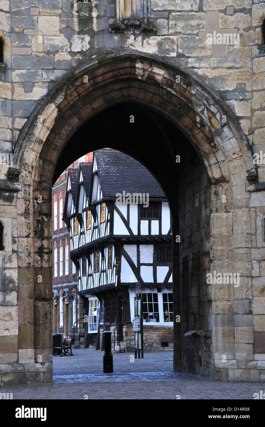 A view of a tudor, timber framed building through a stone archway UK ...