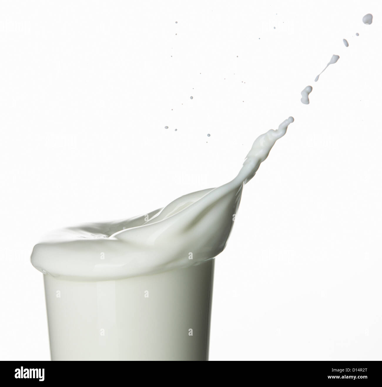 Milk splashing into glass Stock Photo - Alamy